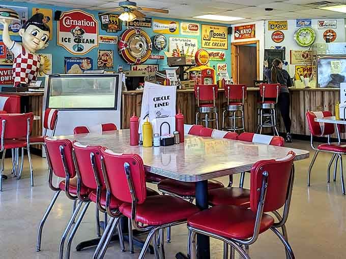 Step inside and you've time-traveled to 1955, complete with chrome, vinyl, and enough vintage signs to make collectors weep.