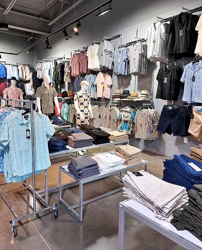 Rows of crisp shirts and casual wear organized like a well-planned dinner party, everything in its perfect place waiting to be discovered.