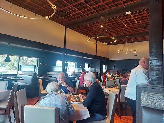 Modern elegance meets comfort food central, where the ceiling design alone deserves its own Instagram account.