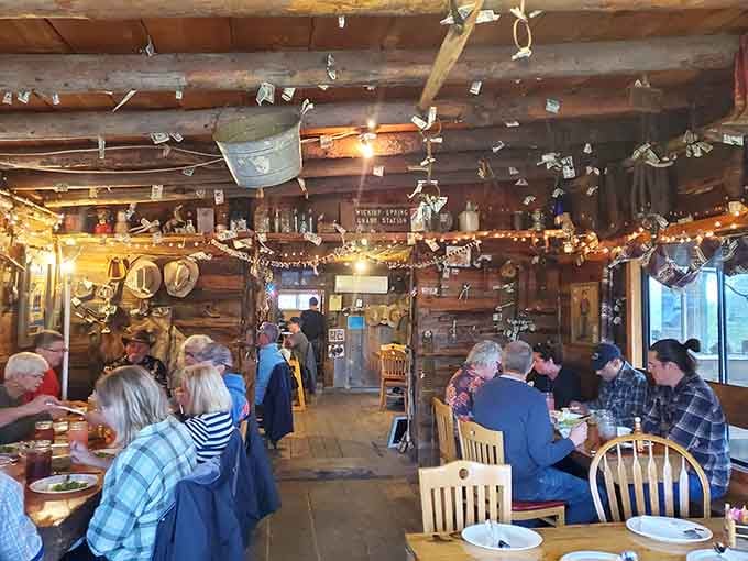Dollar bills on the ceiling, branding irons on the walls, and communal tables where strangers become friends over massive meals.