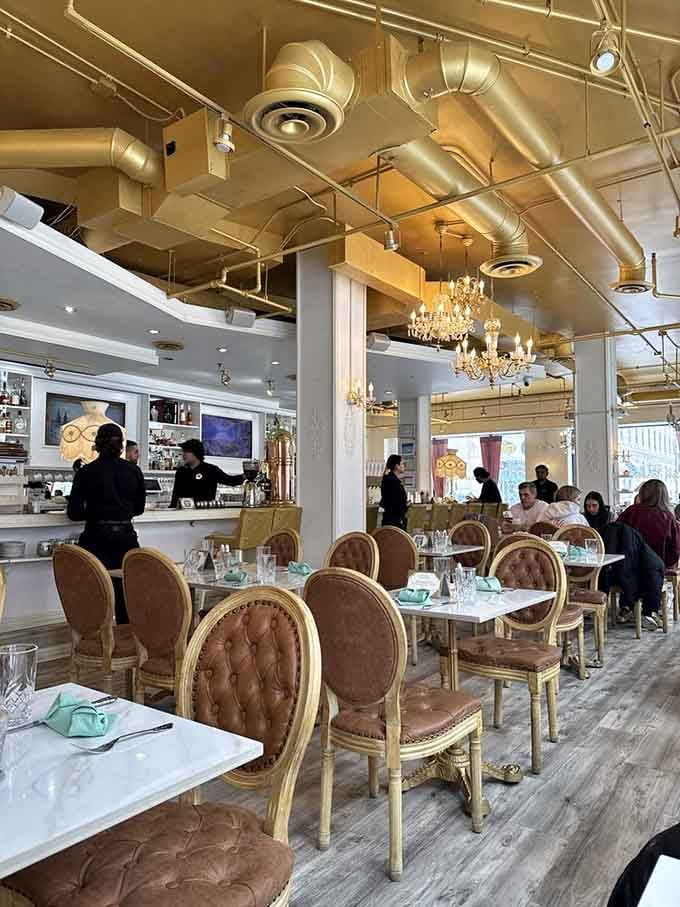 Chandeliers and exposed ductwork living together in perfect harmony, like a French bistro that discovered industrial chic.