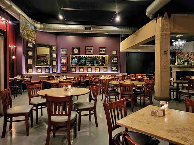 Purple walls and eclectic art create an atmosphere where sophistication meets comfort in perfect harmony.