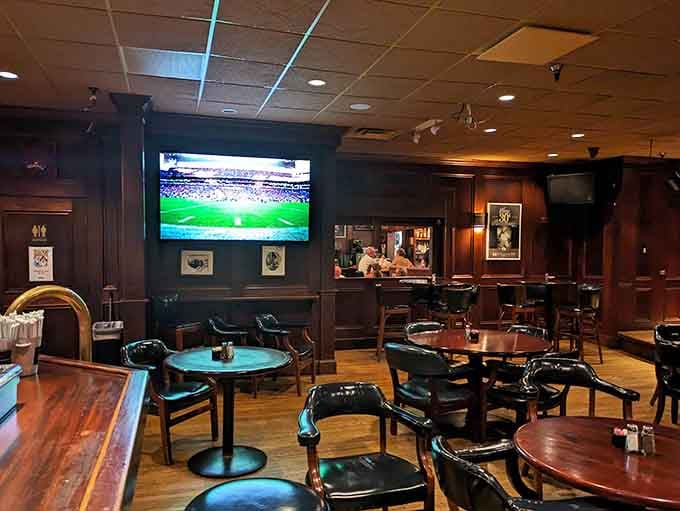 Dark wood, comfortable seating, and multiple screens create the perfect adult atmosphere for relaxing without interruption.