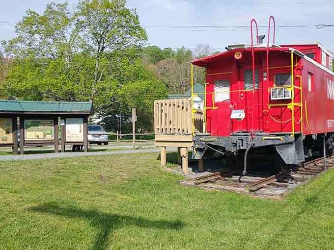 That bright red caboose isn't going anywhere, and honestly, why would it want to leave this perfect spot?