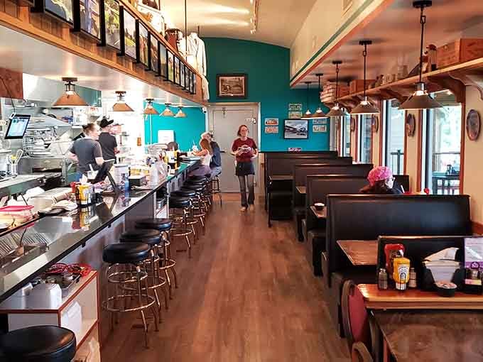 Classic diner stools and a turquoise wall create the perfect setting for your next delicious trip down memory lane.