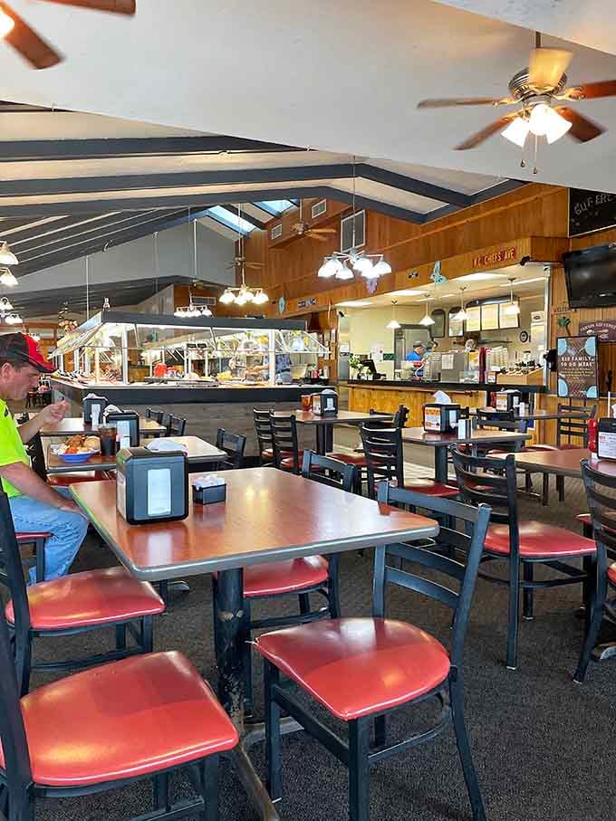 Simple tables, ceiling fans, and a buffet line that stretches like a delicious promise across the room.