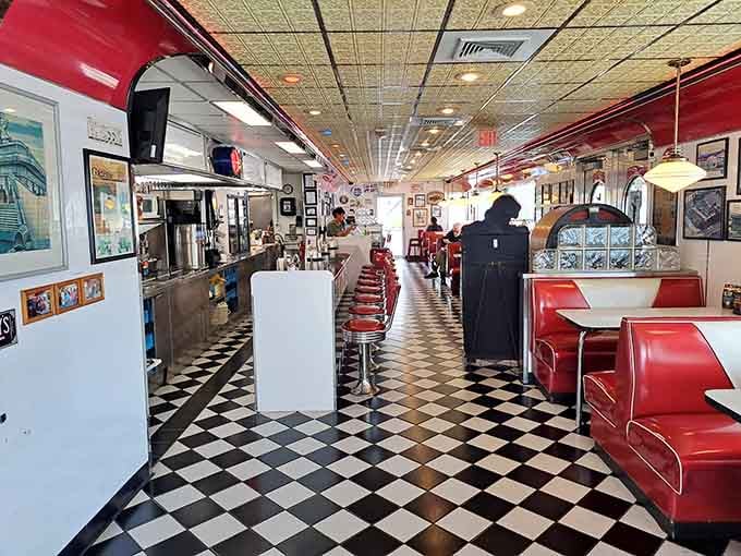 Red vinyl booths, checkered floors, and chrome accents create the perfect setting for serious burger consumption.