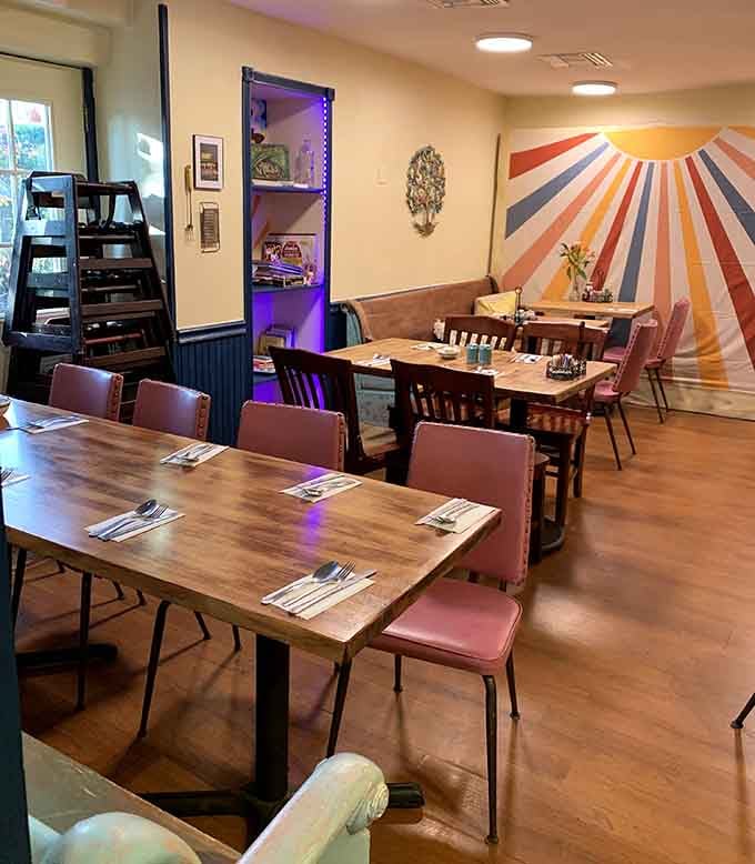 Step inside and let that retro sunburst mural remind you that happiness is a full plate and good company.