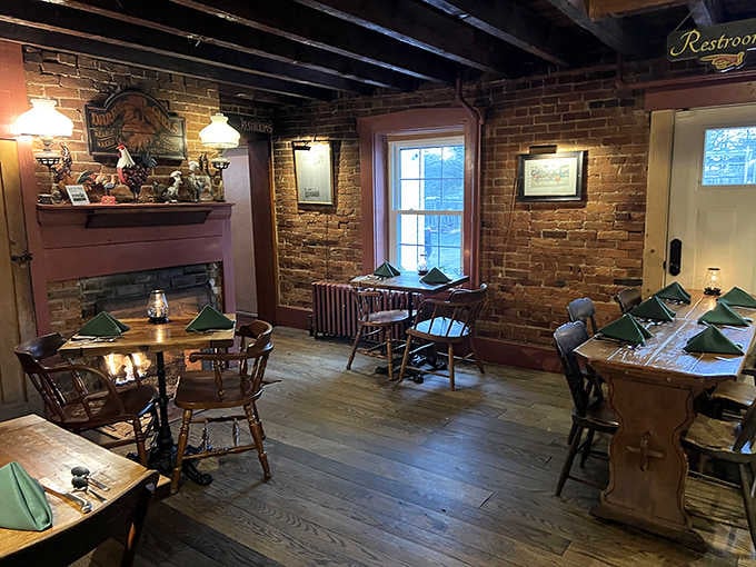 Exposed brick, crackling fireplace, and wooden floors that creak with character create the perfect historic tavern atmosphere.