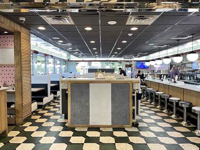 Classic checkered floors meet modern comfort, proving some design combinations never go out of style for good reason.