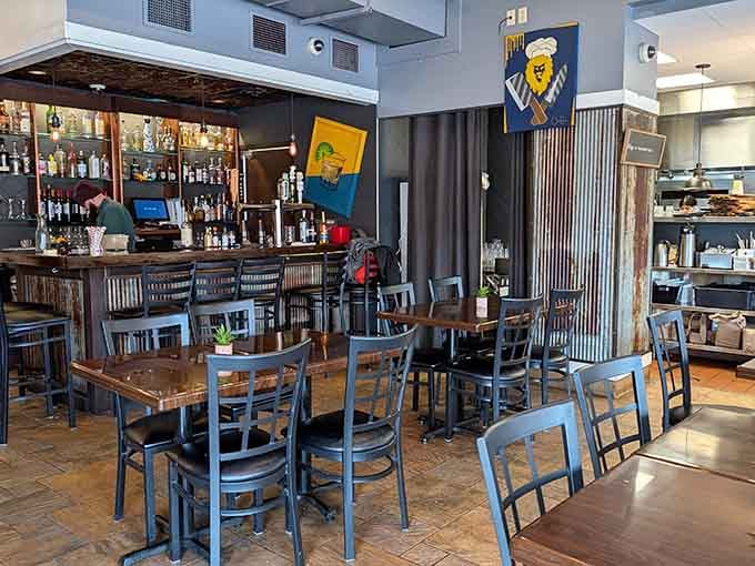 Modern meets cozy in a space where colorful art and polished floors create the perfect dining atmosphere.