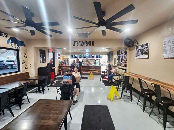 Simple tables, ceiling fans, and that glorious "LET'S TACO 'BOUT IT" sign&mdash;everything you need, nothing you don't.