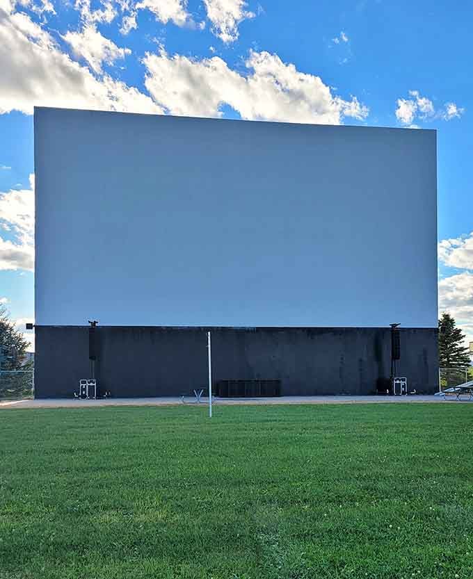 Standing tall against blue skies, this blank canvas awaits tonight's cinematic adventure under the stars.