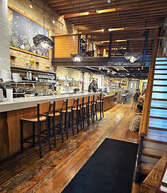Exposed brick, warm wood, and an open kitchen&mdash;it's like someone designed the perfect breakfast stage set.