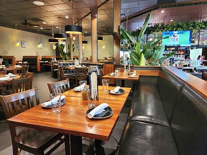 Warm wood tones and cozy booths create the perfect setting where comfort food meets culinary excellence in every corner.