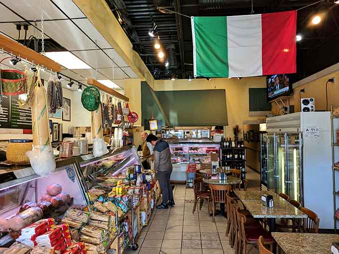 Step inside where Italian flags fly proud and deli cases stretch like edible museums of cured meat perfection.