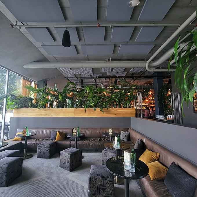 Low-slung lounge seating meets industrial chic in this corner where comfort becomes an art form.