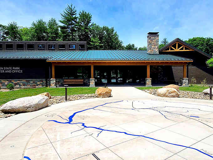 The visitor center welcomes you with that blue river map, your gateway to adventures that don't require a passport.