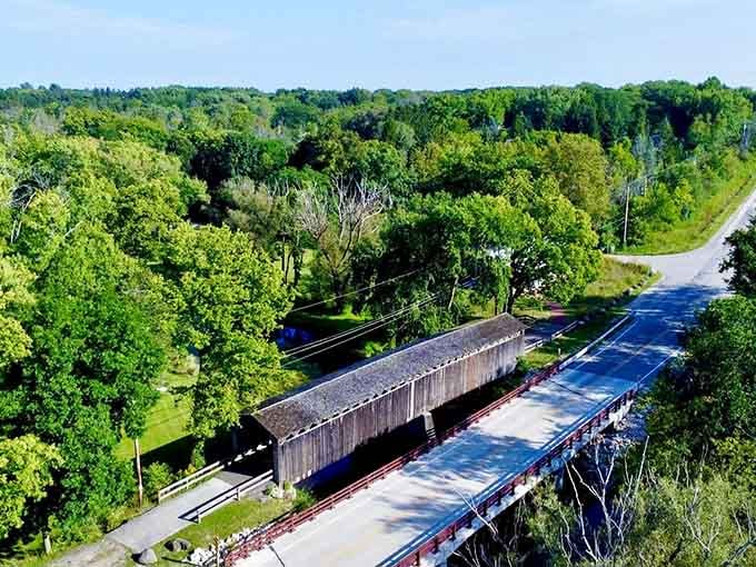 From above, the bridge looks like a wooden ribbon connecting past and present across Cedar Creek's gentle waters.