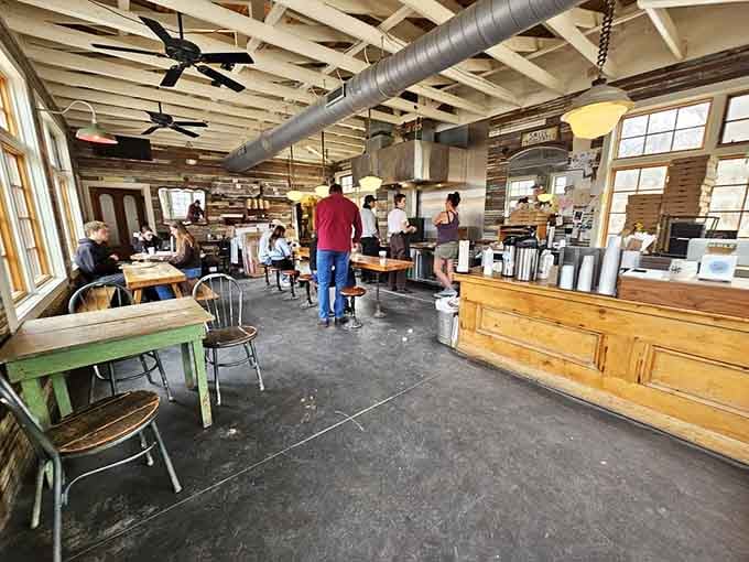 Industrial chic meets cozy neighborhood bakery, where exposed beams and communal tables create the perfect donut sanctuary.