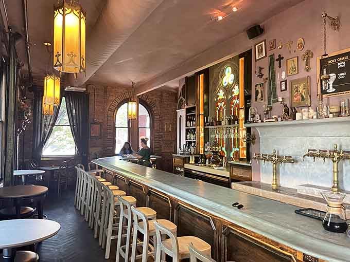 Inside Holy Grale, exposed brick and vintage lighting create an atmosphere where European pub culture meets Kentucky hospitality perfectly.