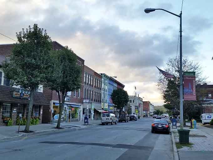 Those twilight-hour streetlights hitting historic buildings just right, like a movie set that forgot to stop being charming.