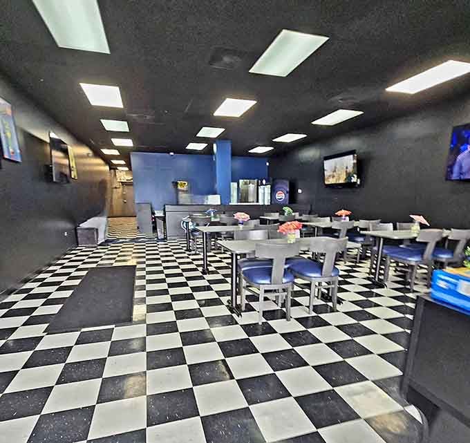 Classic checkered floors meet modern blue accents in a space that says "relax and eat well."