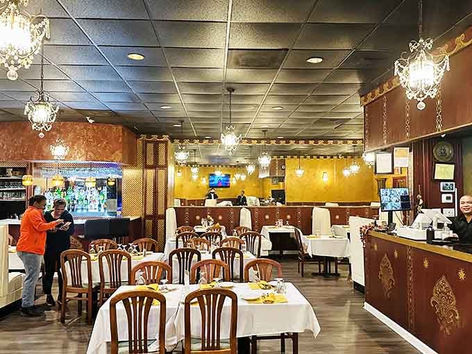 Crystal chandeliers and warm golden walls create an atmosphere that says "special occasion" even when it's just Tuesday lunch.