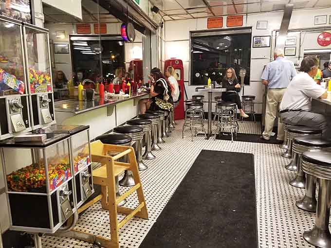 Classic counter seating where you can watch the burger ballet unfold, checkered floors and all.