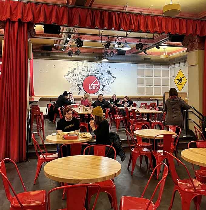 Red chairs and theatrical curtains set the stage for what might be Wisconsin's most creative pizza performance.