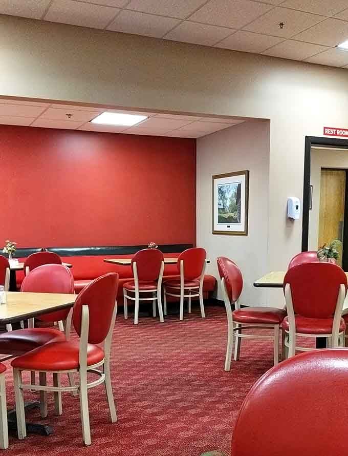 Red chairs and simple tables create the perfect no-nonsense setting where food takes center stage, not Instagram-worthy decor.