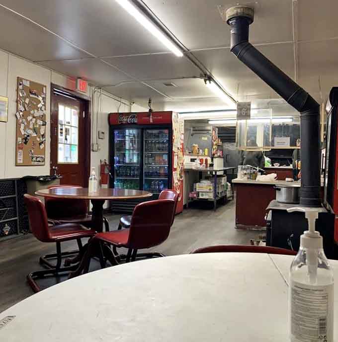 This is what BBQ dreams look like: no-frills seating, Coca-Cola coolers, and that beautiful smoker working its magic.