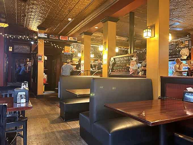 Tin ceilings and string lights create the kind of ambiance that makes you want to linger over another round.