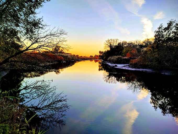 Golden hour transforms ordinary water into liquid fire, no Instagram filter required for this natural spectacle.