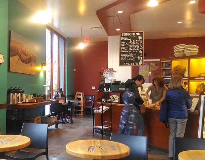 Inside Ken's Artisan Bakery, where the warm lighting matches the warm bread and everyone's about to make some delicious decisions.