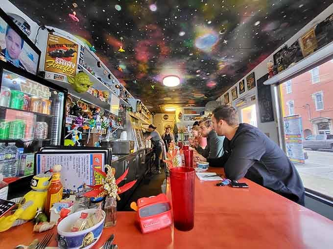 Dining under a painted galaxy makes every sandwich taste like it's been blessed by the cosmos itself.