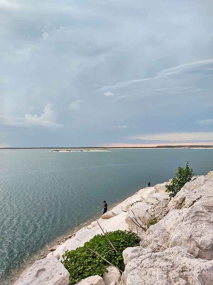 Crystal clear waters meet ancient limestone cliffs in a scene that belongs on a postcard.