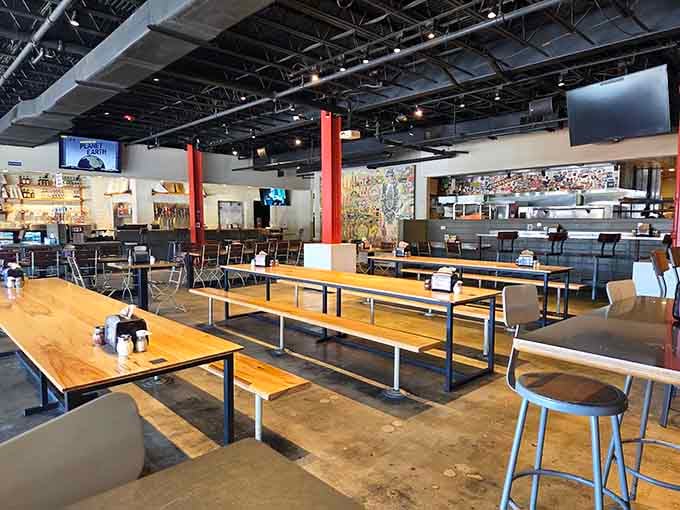 Communal tables and industrial chic vibes create the perfect setting for your upcoming battle with gravity-defying slices.