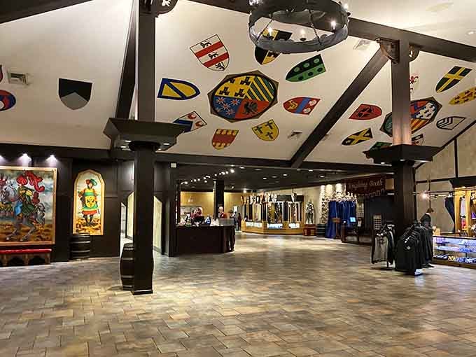 Heraldic shields overhead and timber beams create an atmosphere fancier than most people's actual dining rooms.