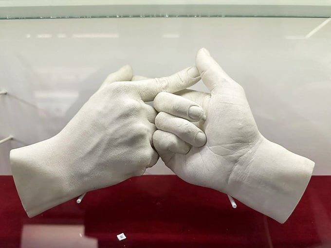 These plaster hands tell stories without saying a word, frozen in a gesture that speaks volumes about connection.