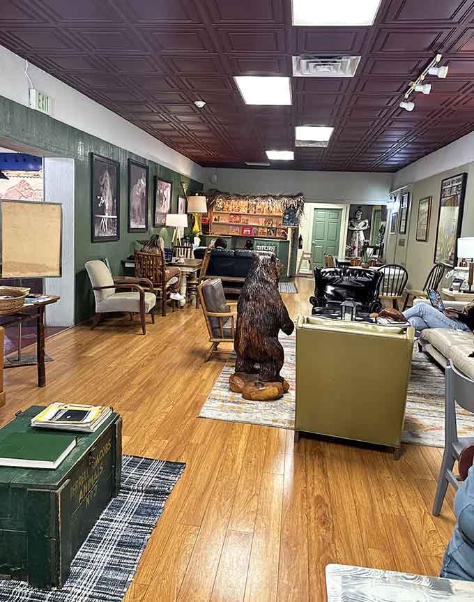 A wooden bear guards the coffee bar like it's protecting the last cinnamon roll at Sunday brunch.