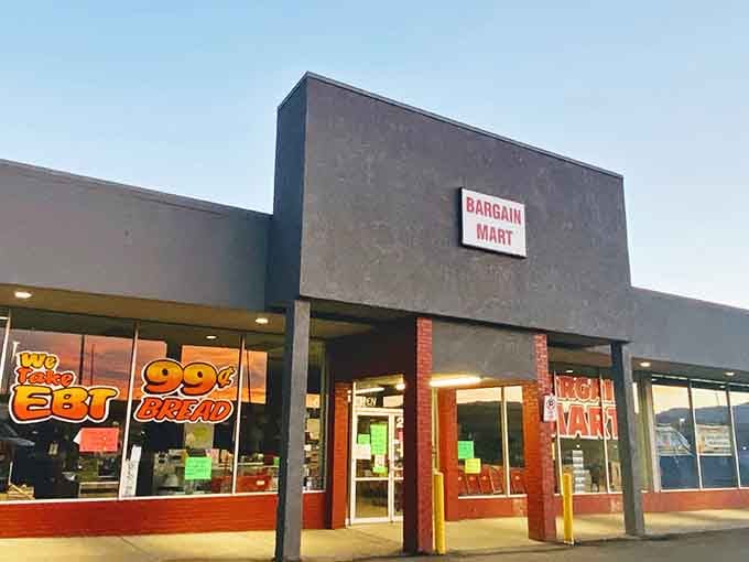The friendly storefront features large windows reflecting the sunset, inviting shoppers inside to discover various everyday essentials and great deals.