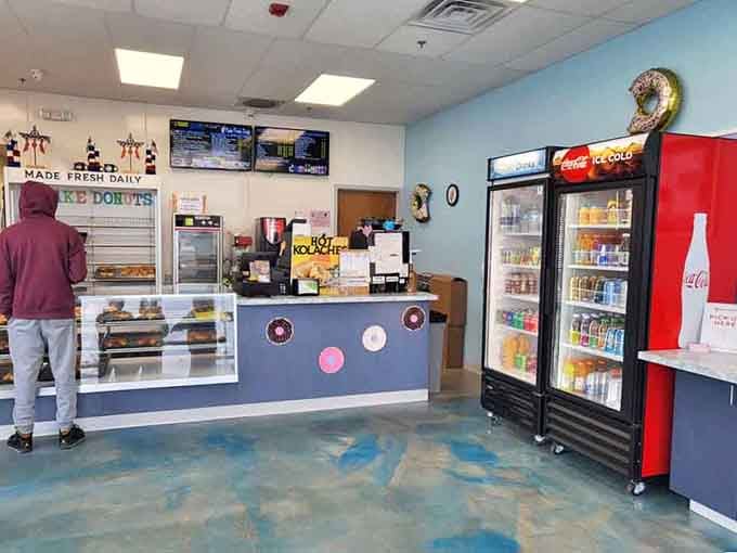 Step into a space where the marbled floor reflects the glow of fresh donuts and pure possibility.
