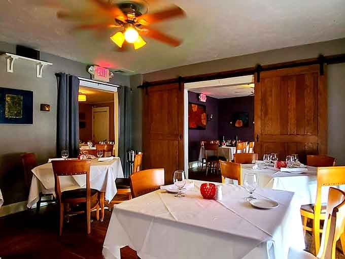 White tablecloths and warm lighting create the perfect setting where comfort meets sophistication without any stuffiness whatsoever.