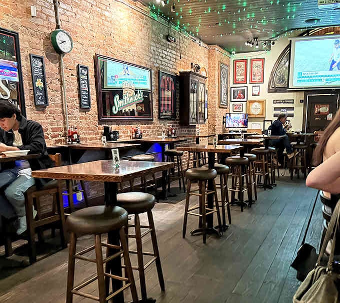 Exposed brick, string lights, and high-top tables create the kind of atmosphere where strangers become friends.