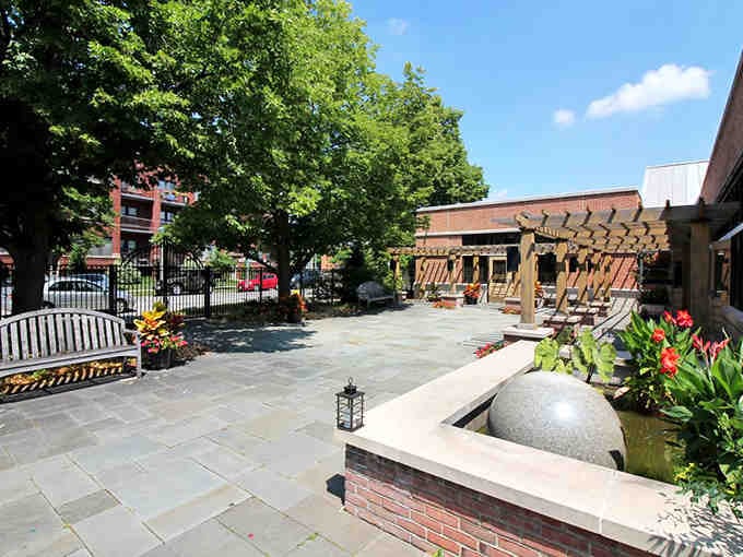 Your secret garden entrance awaits, complete with fountain and flowers that actually survived the season.