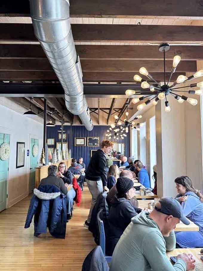 Modern industrial meets neighborhood warmth, where exposed beams and communal tables turn strangers into breakfast buddies over coffee.