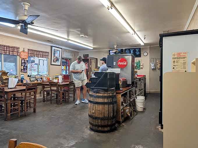 Simple wooden tables, concrete floors, and a decorative barrel create the perfect no-frills atmosphere for exceptional smoked meat.