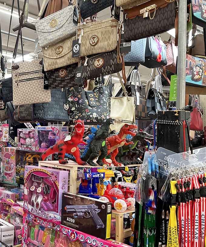 Designer bags hanging above toy dinosaurs is the kind of beautiful chaos that makes flea markets absolutely irresistible.
