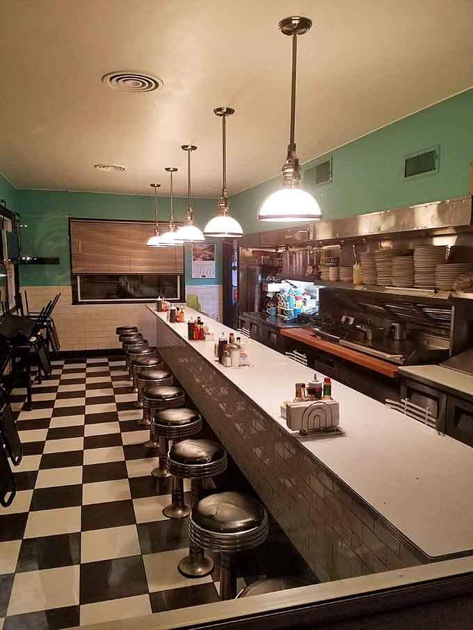 Classic chrome stools and checkered floors transport you straight to 1950s America, minus the questionable Jell-O salads.